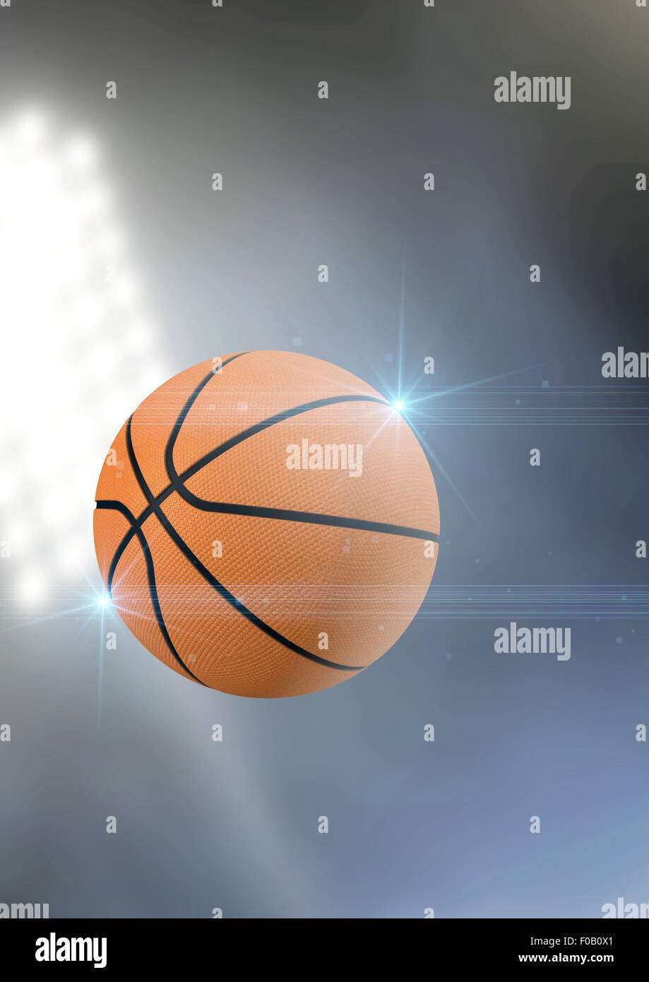 A regular basketball flying through the air on an a outdoor stadium ...