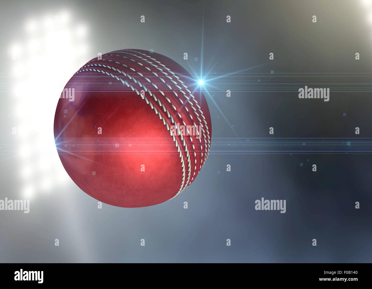 A regular red cricket ball flying through the air on an a outdoor ...