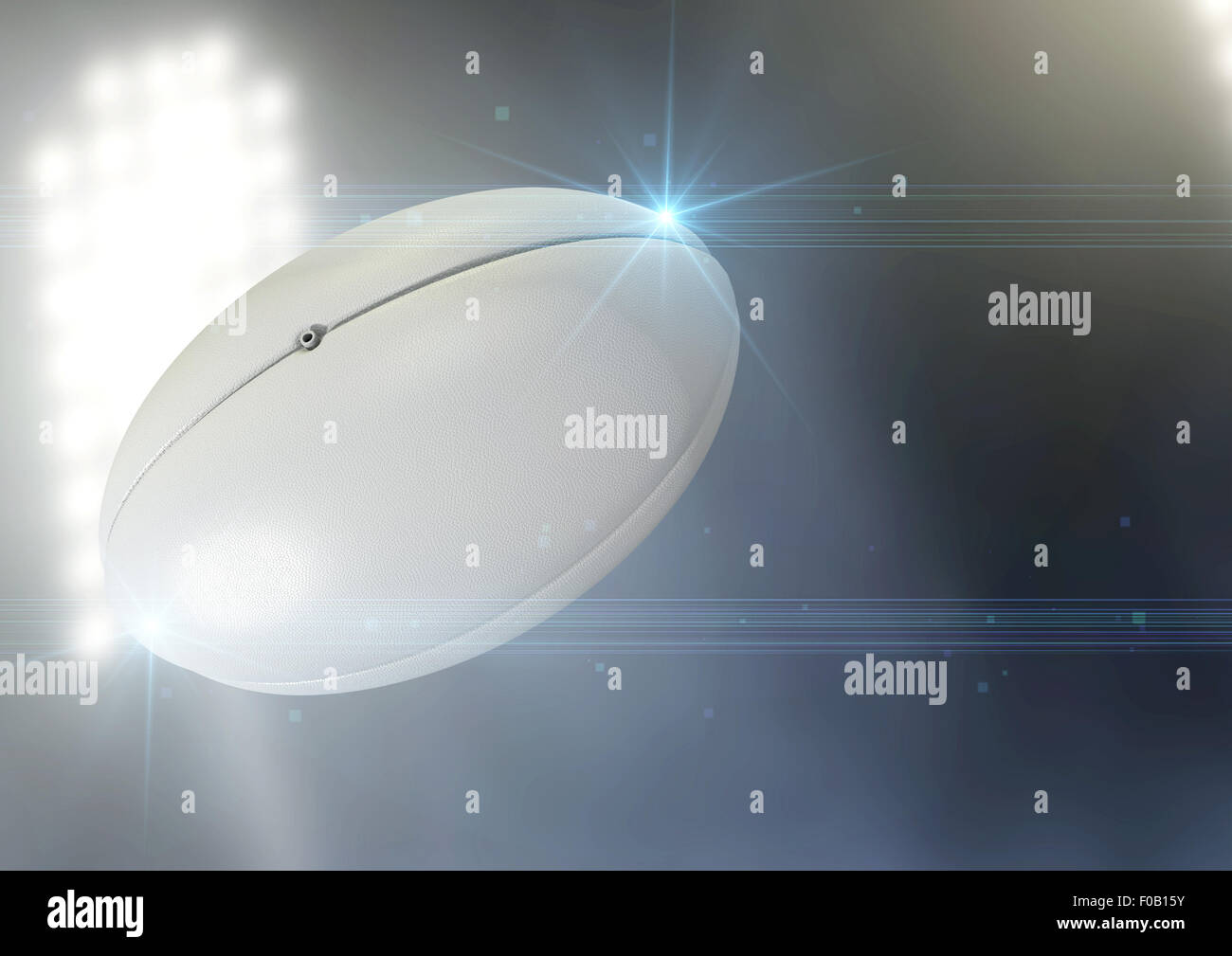 A regular rugby ball flying through the air on an a outdoor stadium ...