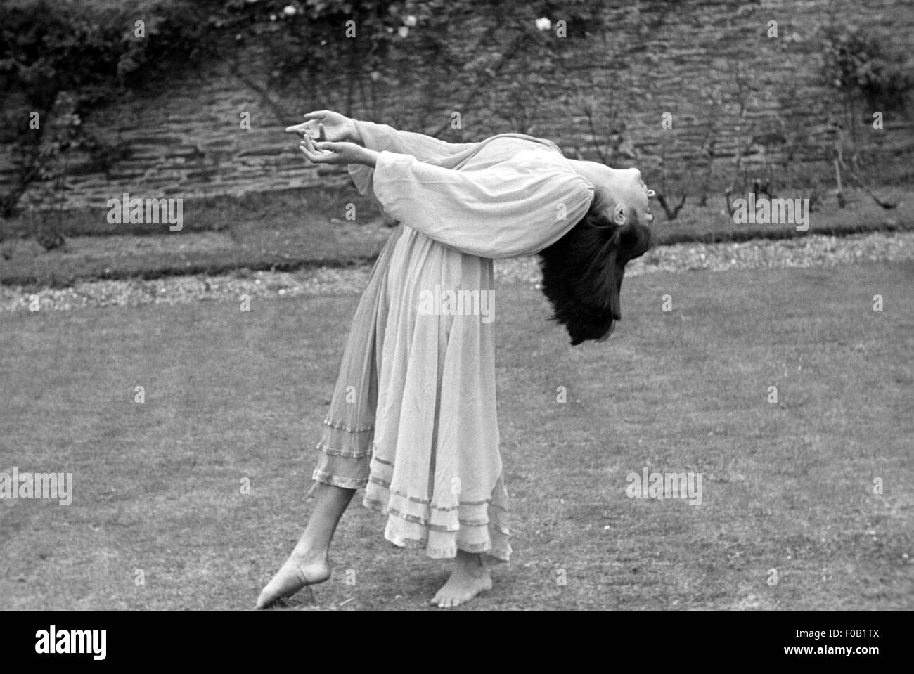 A young woman dancing in a garden Stock Photo - Alamy