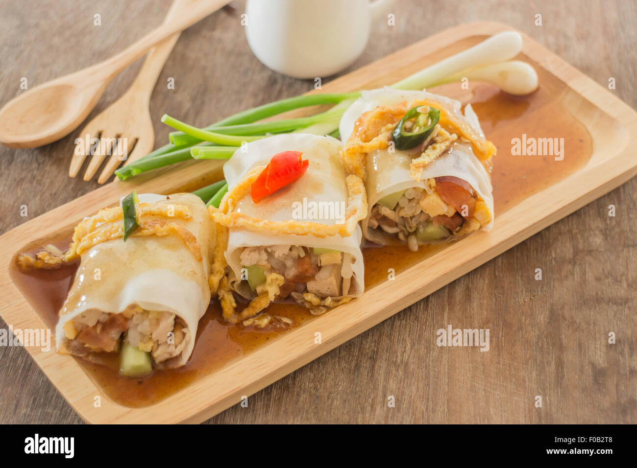 Spring rolls with vegetables and chicken on wooden plate, stock photo ...