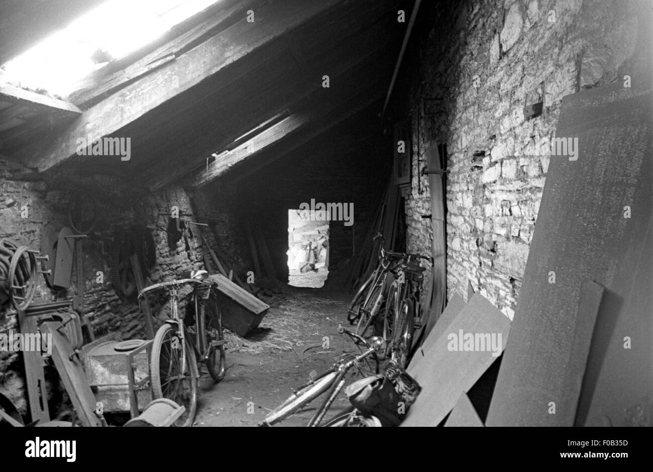 A lean-to on the side of a stone house with bikes lined up Stock Photo ...