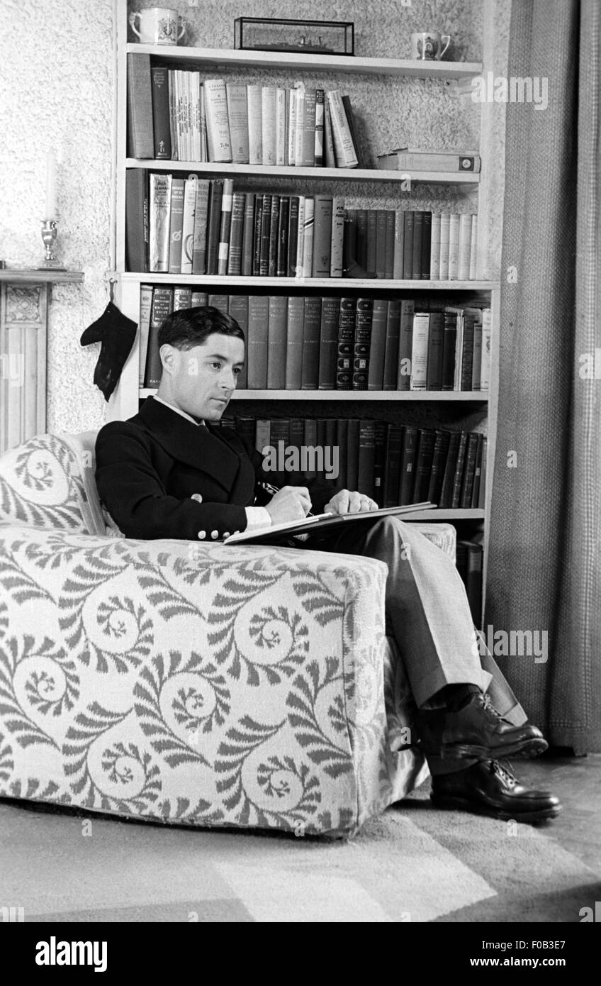 Sitting young man holding Black and White Stock Photos & Images - Alamy