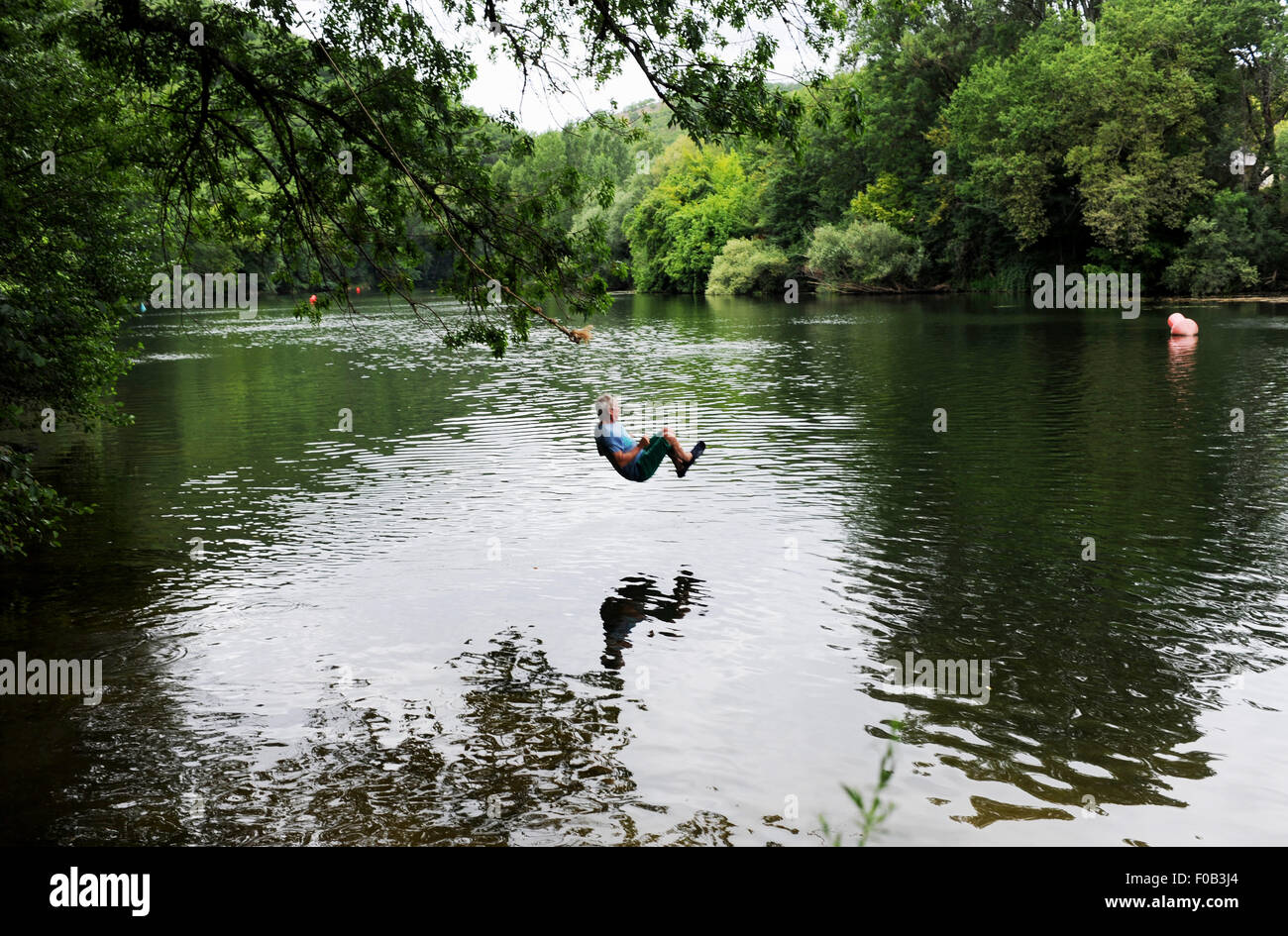 Man jumping from rope swing hi-res stock photography and images - Alamy