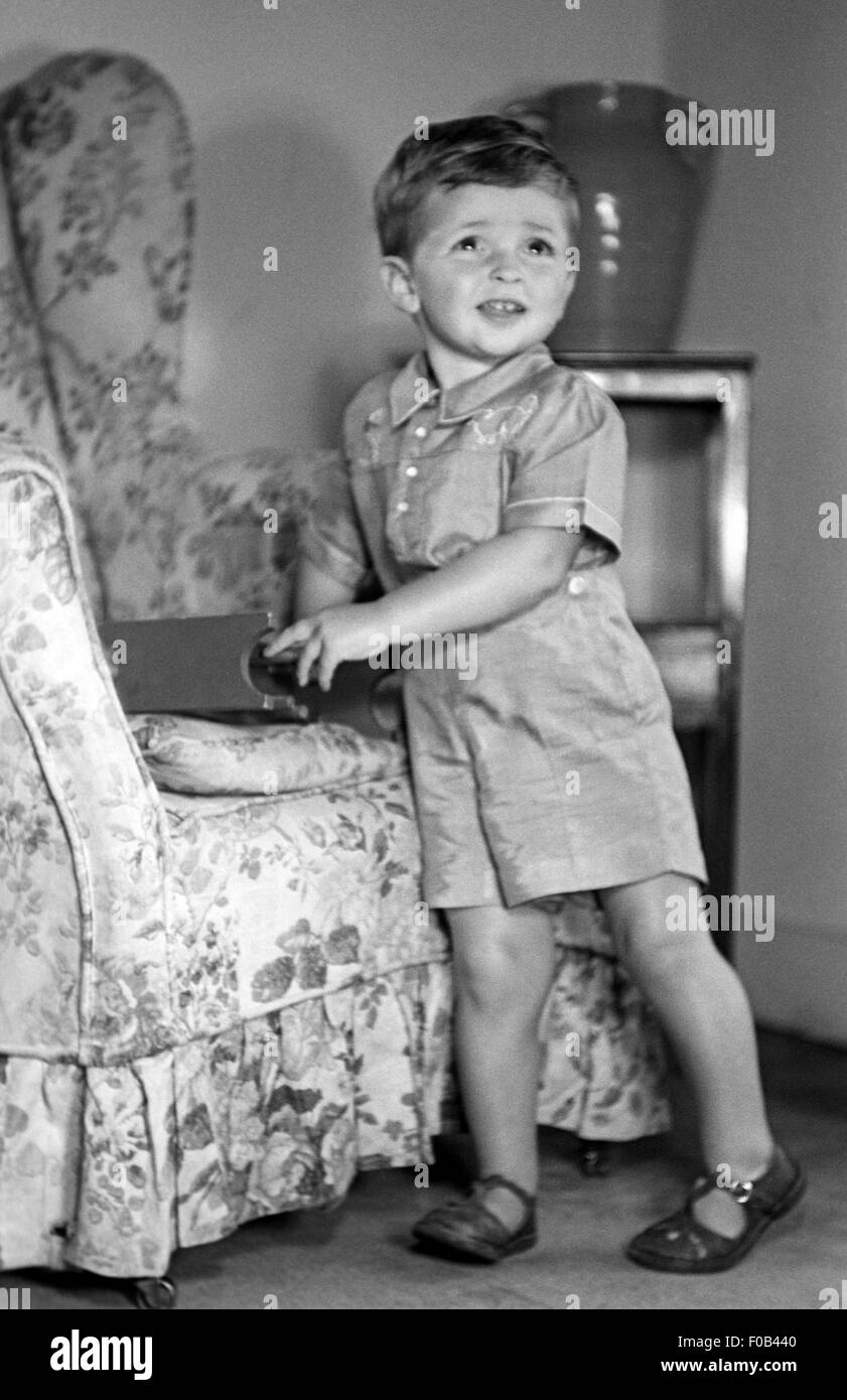 Child standing next to chair hi-res stock photography and images - Alamy