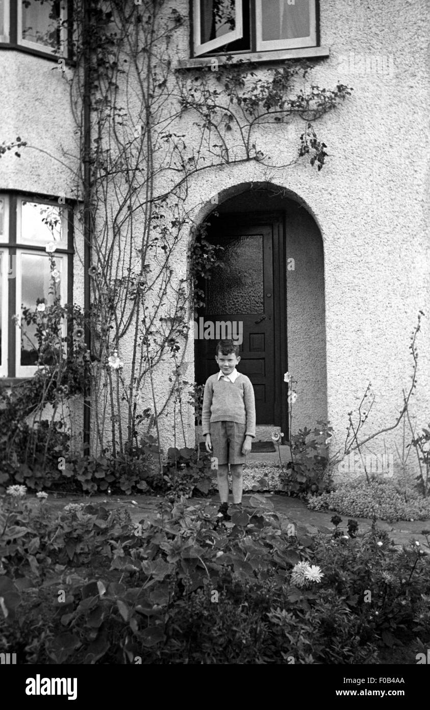 A boy standing outside a house Stock Photo - Alamy
