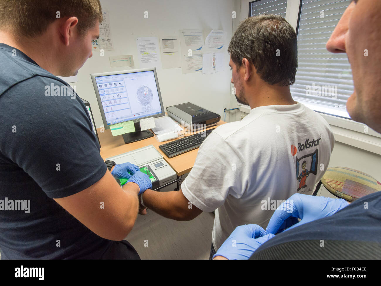 Deggendorf, Germany. 11th Aug, 2015. A refugee's fingerprints are ...