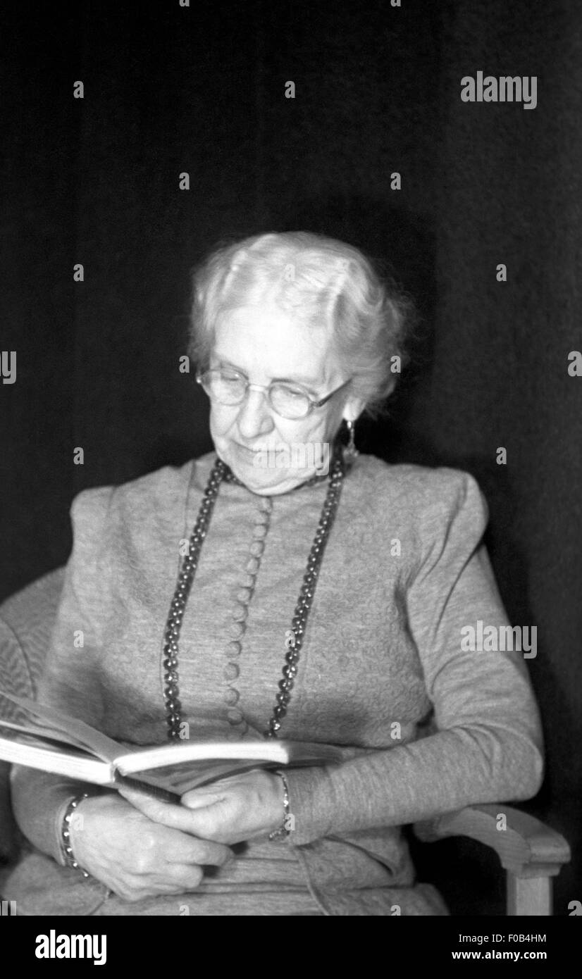Old lady reading a book Stock Photo - Alamy