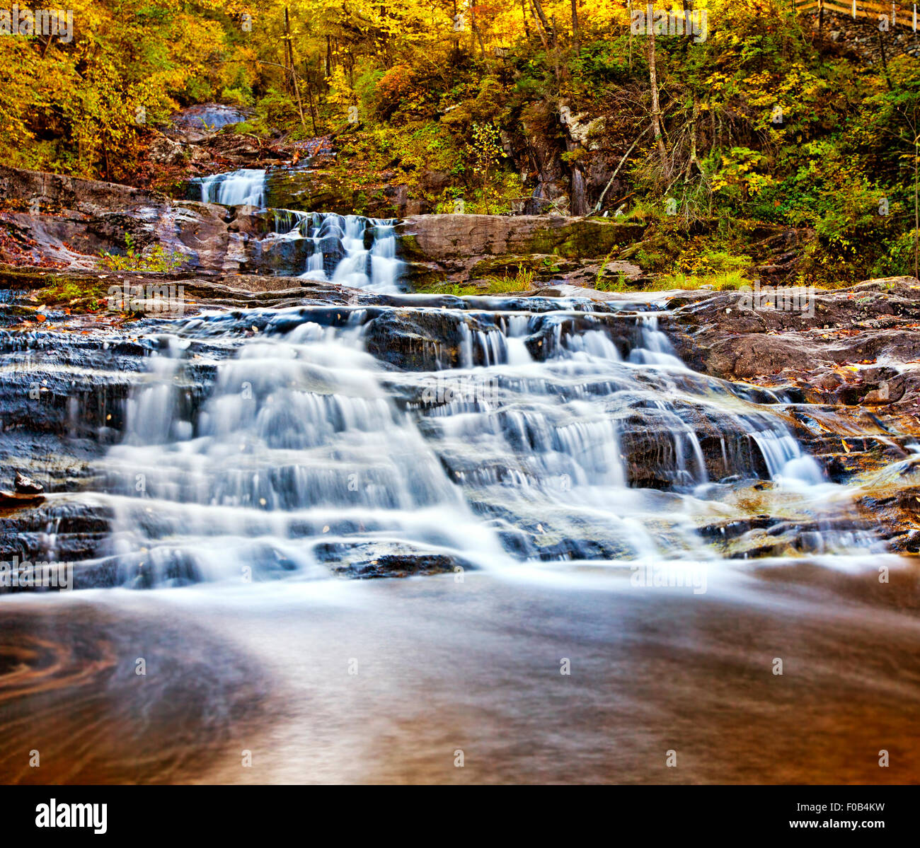 Beautiful fall leaves on rocks above flowing water, long exposure Stock ...