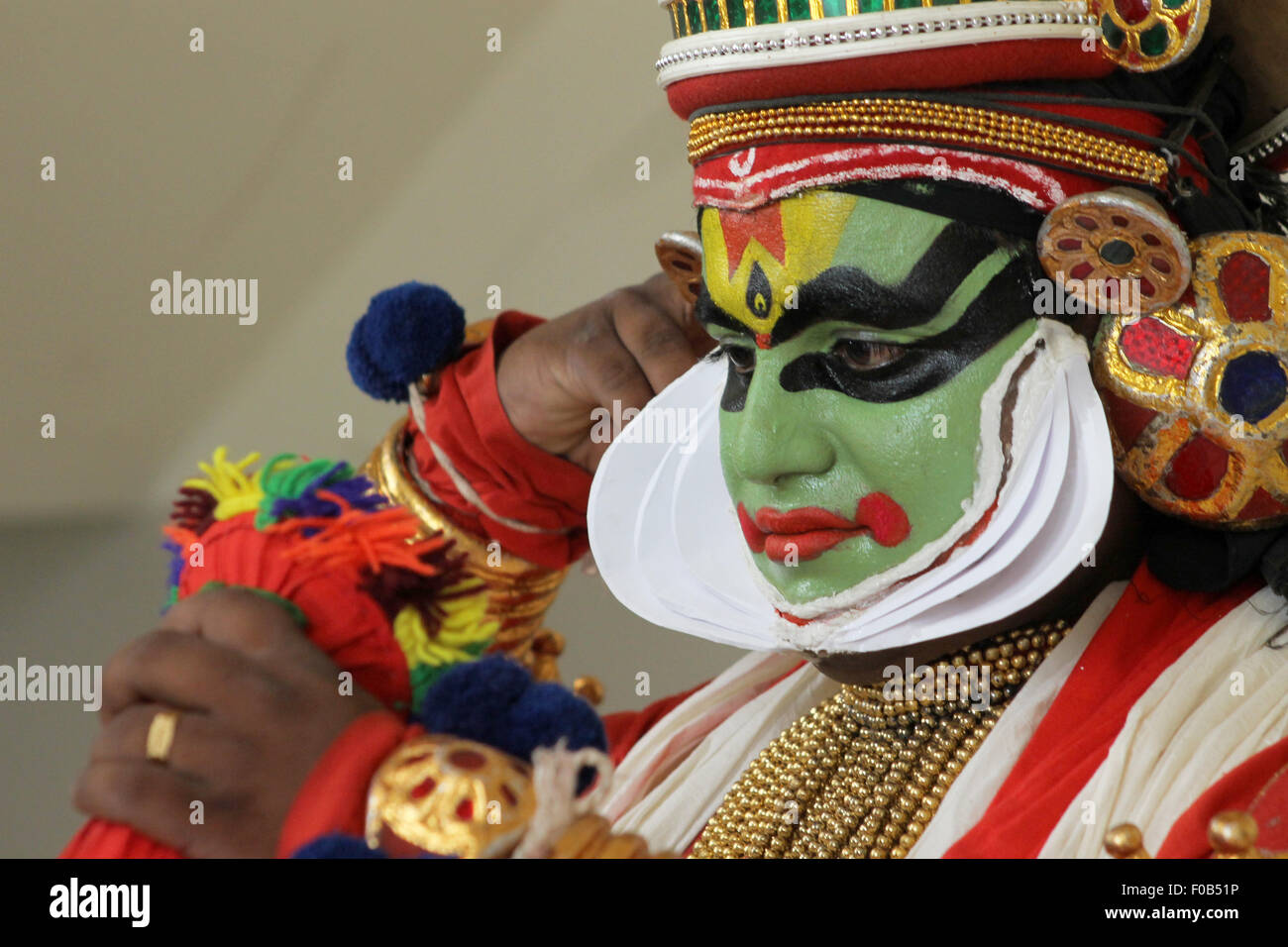 Kathakali artist checking his make up before the performance ...