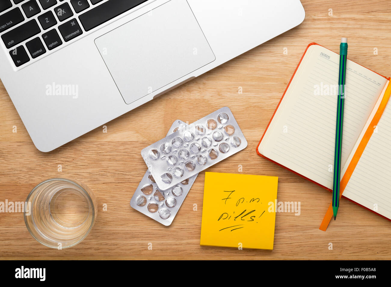 Pills,laptop, notepad with pencil and glass of water Stock Photo - Alamy