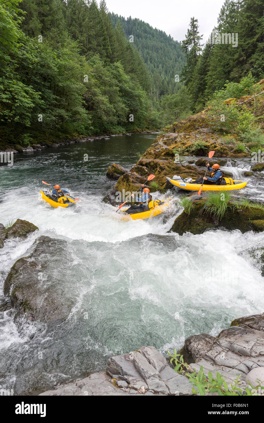 Multiple exposure of paddling an inflatable kayak down a small ...