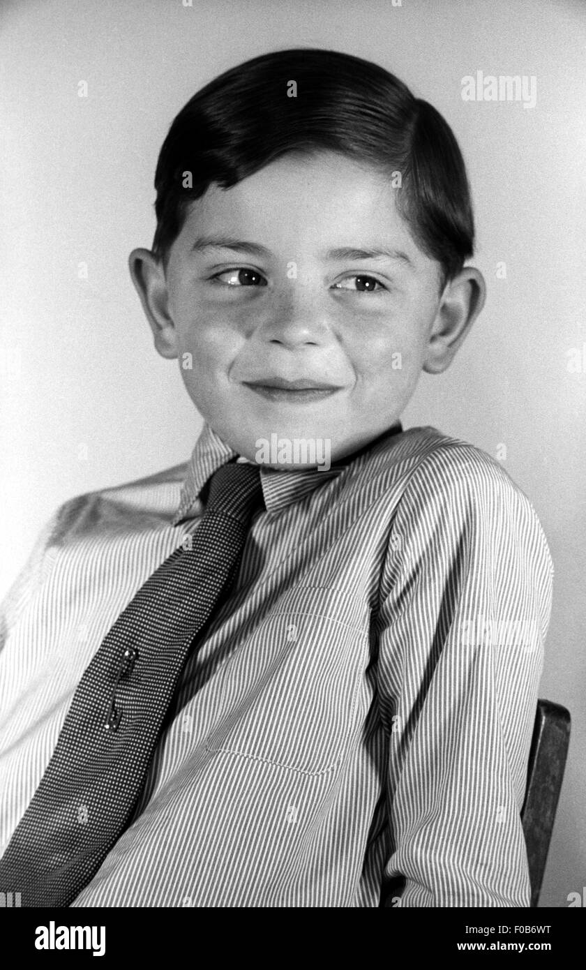 A smartly dressed boy with dark hair smiling Stock Photo - Alamy