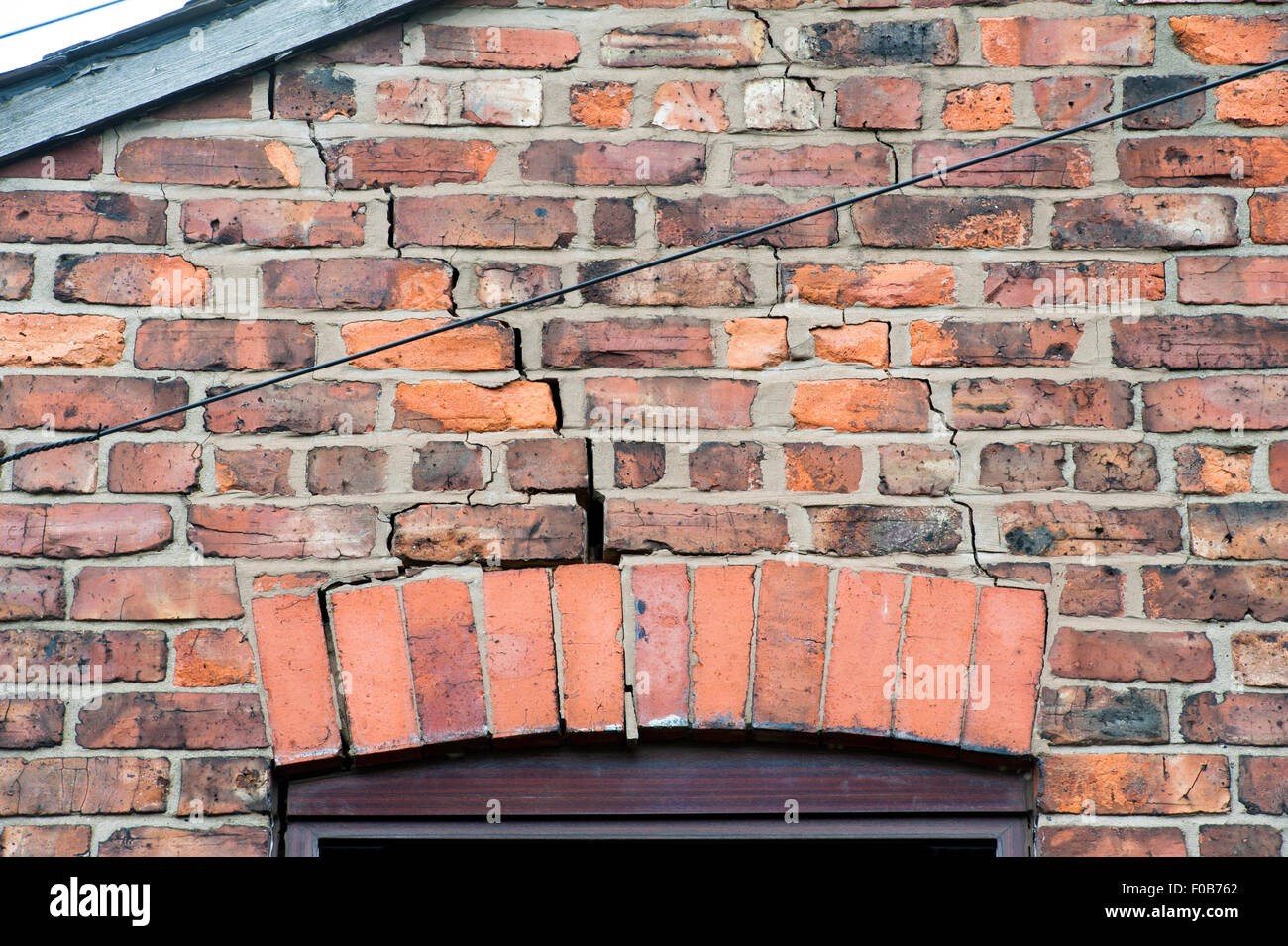 step cracking damage to brickwork in a wall above a window as a result ...