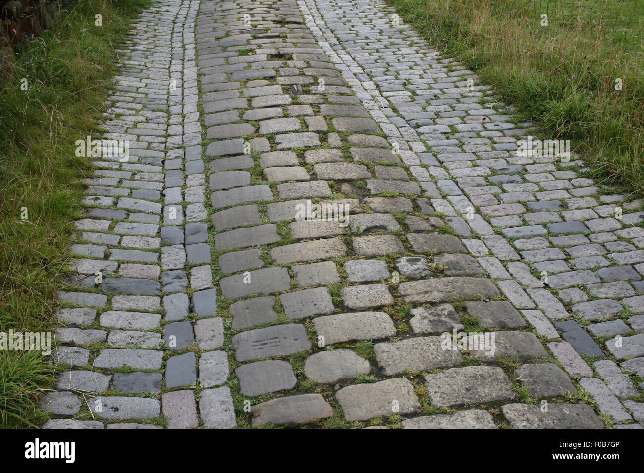 Cobbled road in Yorkshire countryside, hardwearing granite setts with ...