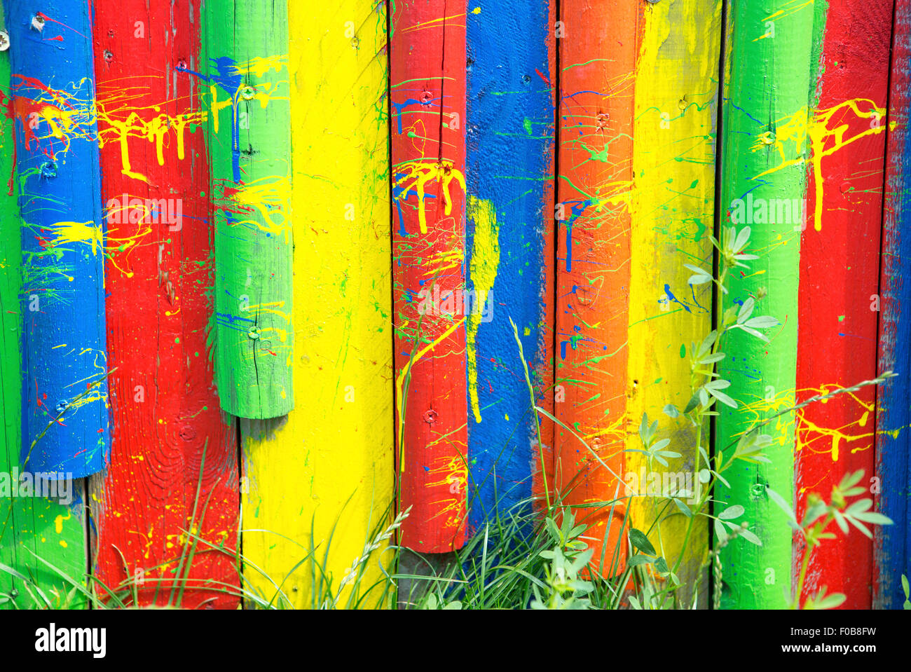 colorful wooden fence painted and with grass Stock Photo - Alamy