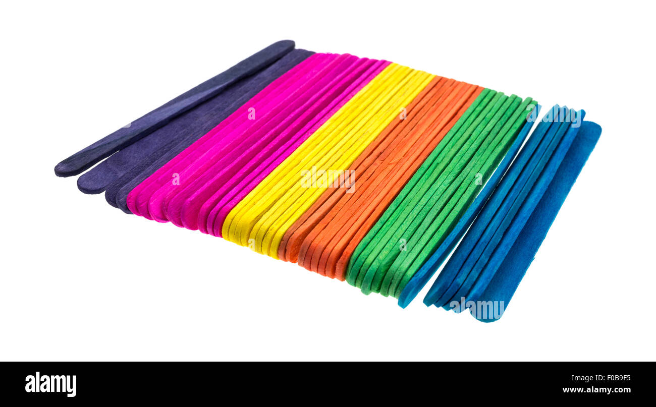 Side view of a group of new colorful craft sticks isolated on a white ...