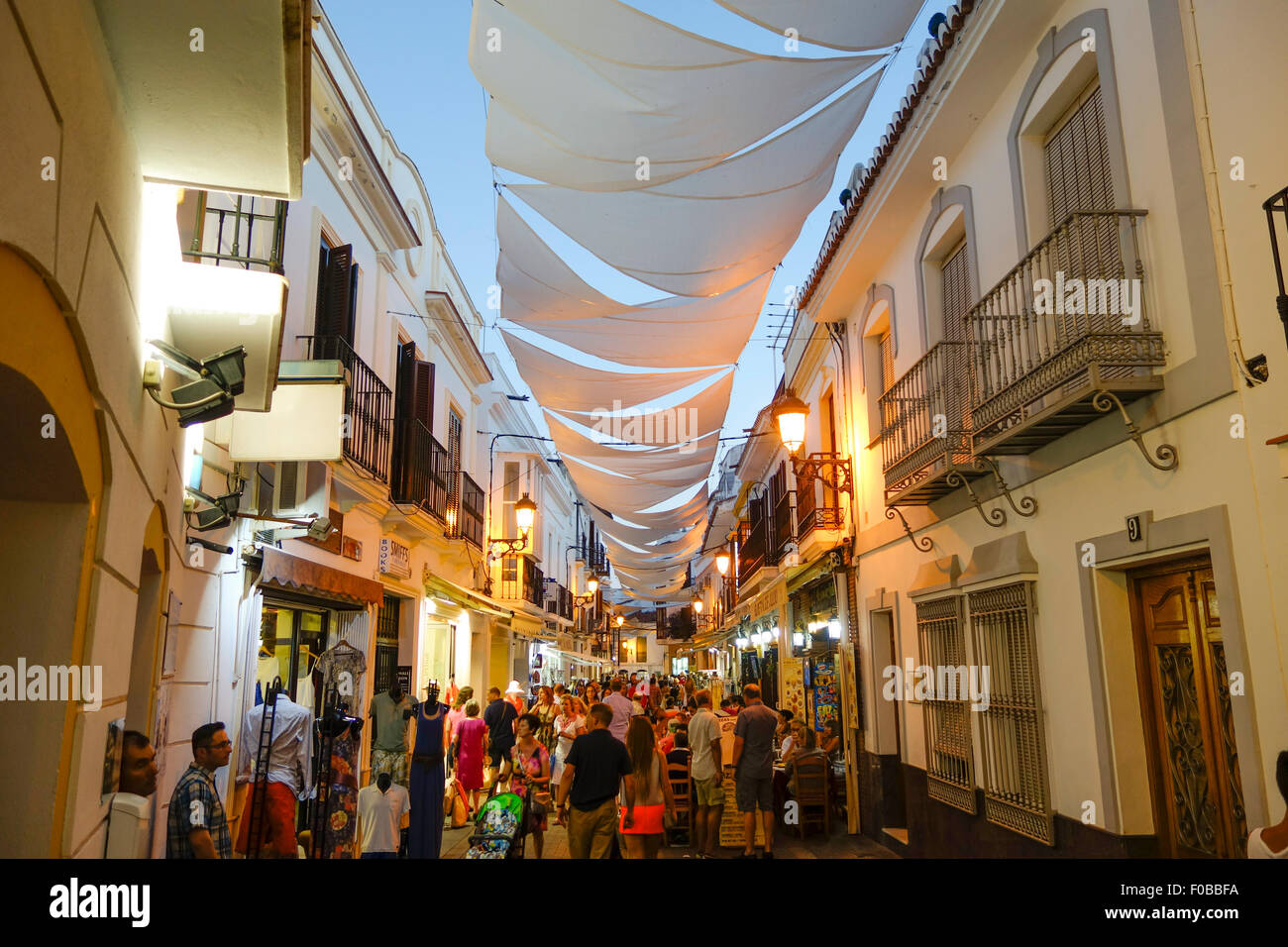 Tourists in Street in Andalusian white village of Nerja covered with ...