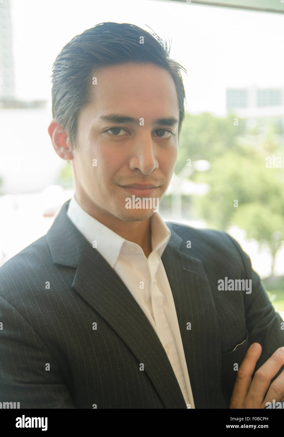 Asian Man in Library wearing suit Stock Photo - Alamy