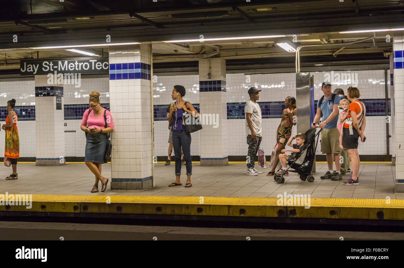 Subway riders wait for a train at the Jay Street-MetroTech station in ...