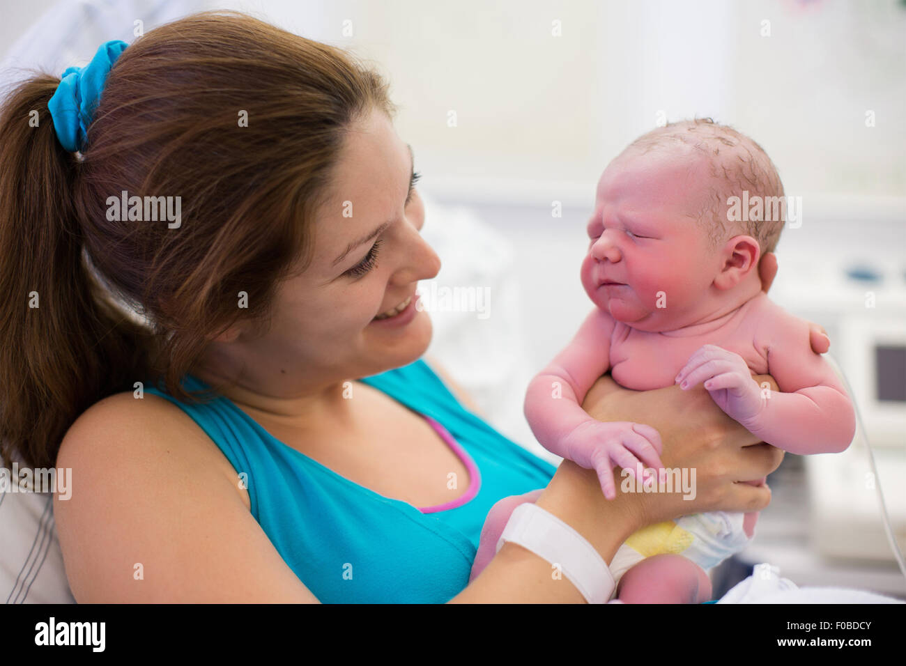 Mother giving birth to a baby. Newborn baby in delivery room. Mom ...