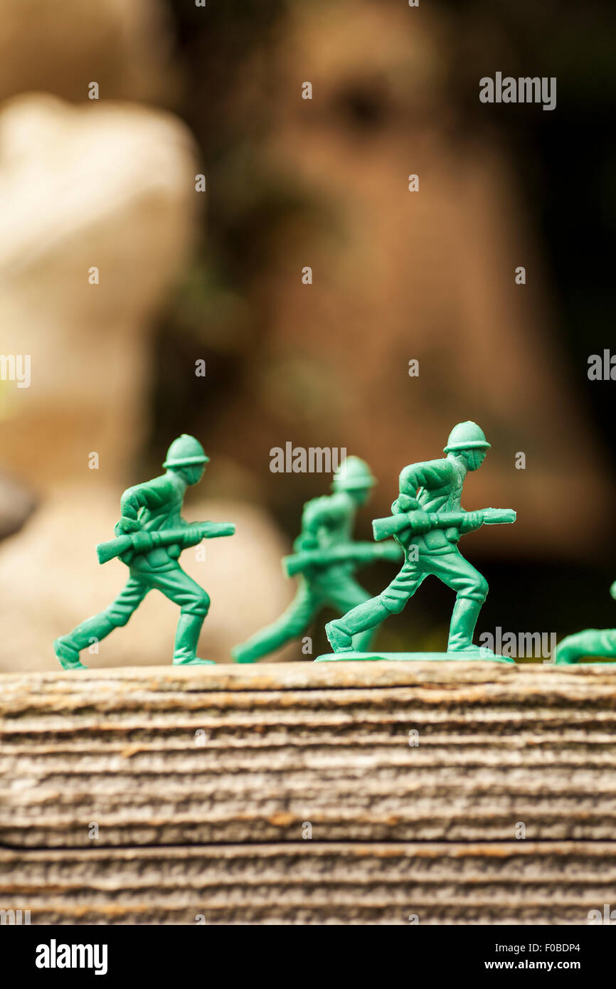 Green plastic toy soldiers/army men on a mission in the back garden ...