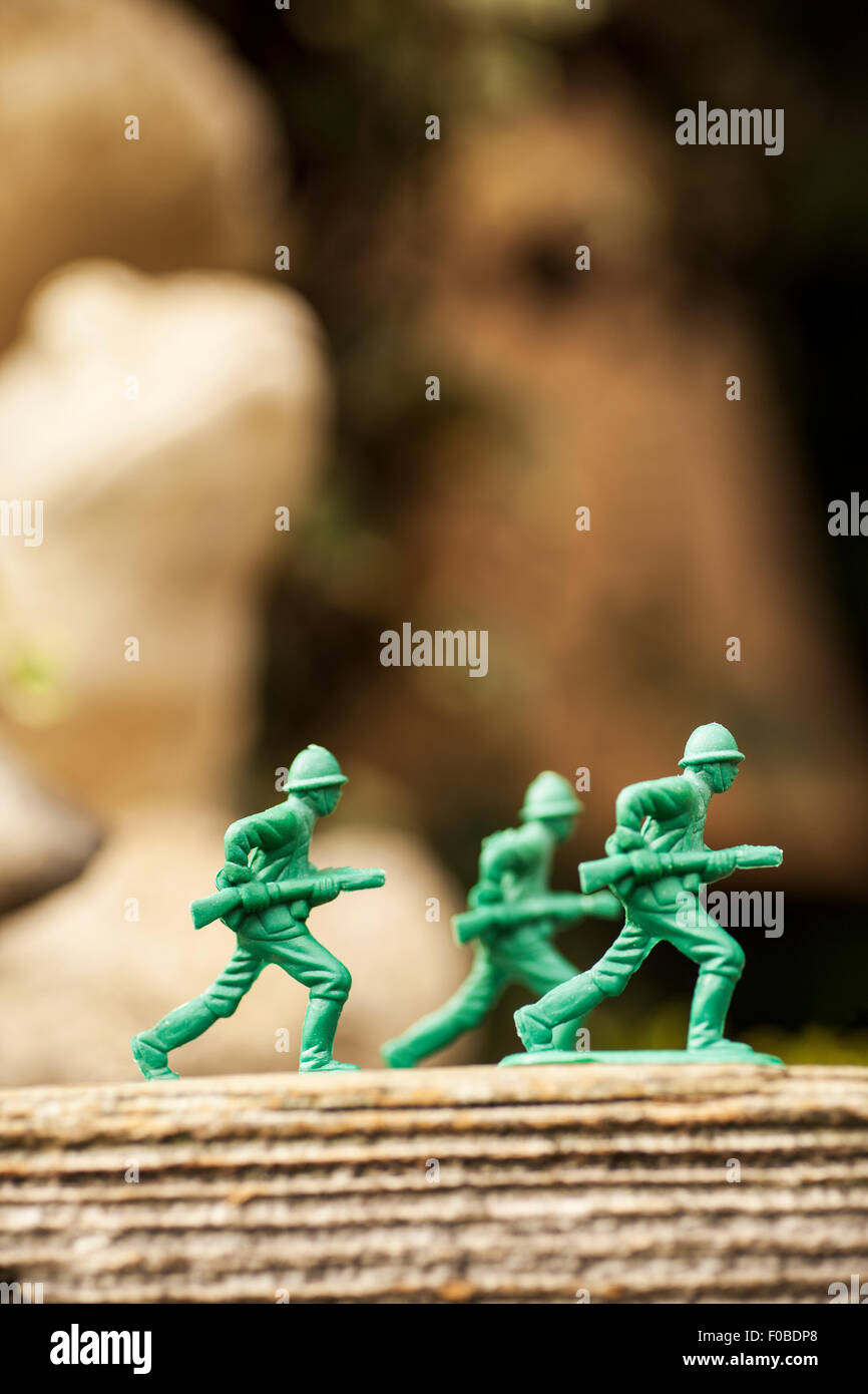 Green plastic toy soldiers/army men on a mission in the back garden ...