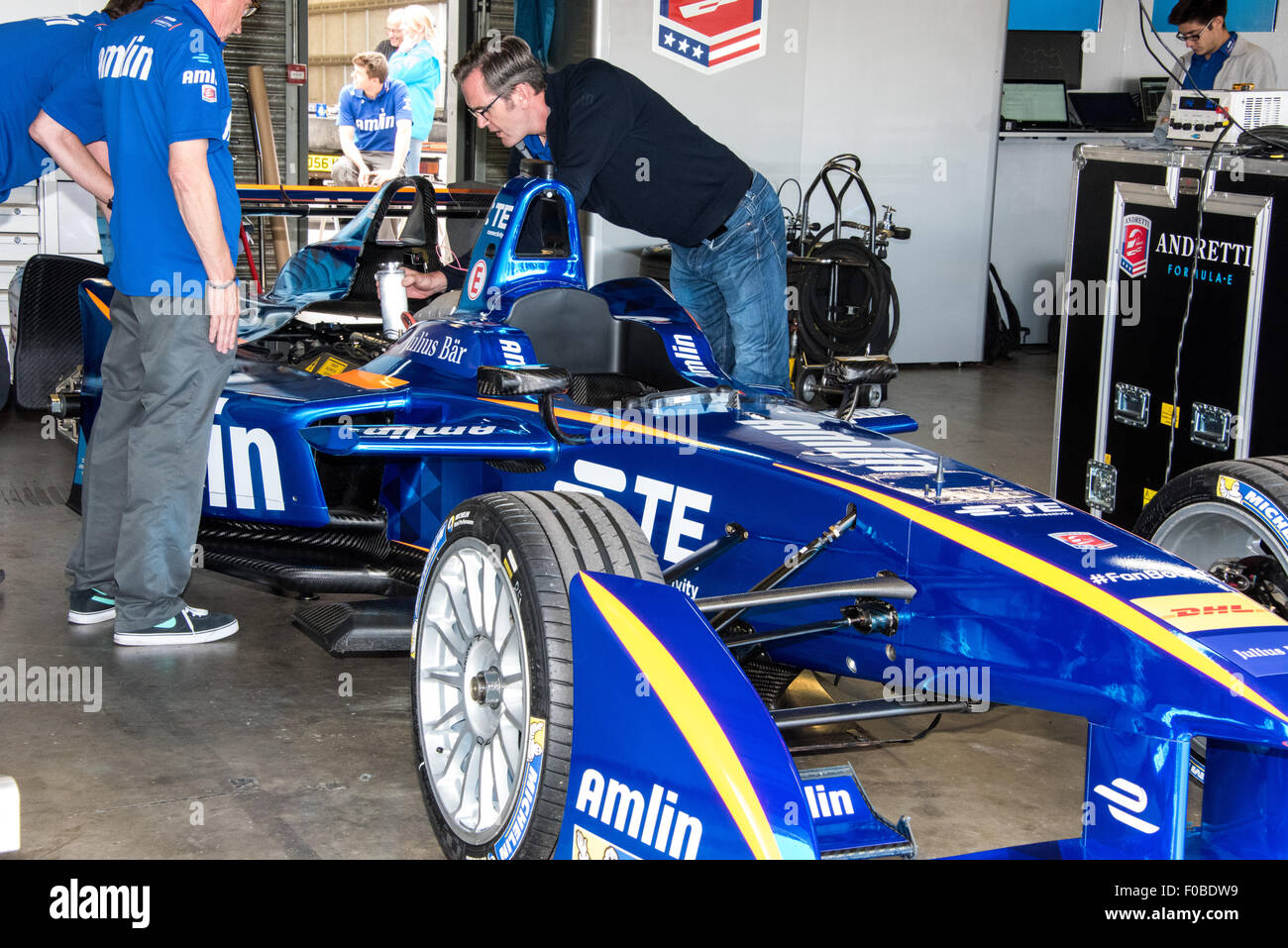 Mechanics working on Formula E racing cars during a break in testing at ...