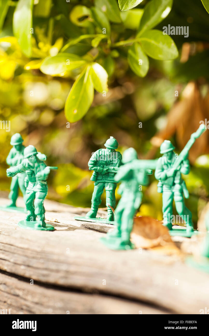 Green plastic toy soldiers/army men on a mission in the back garden ...
