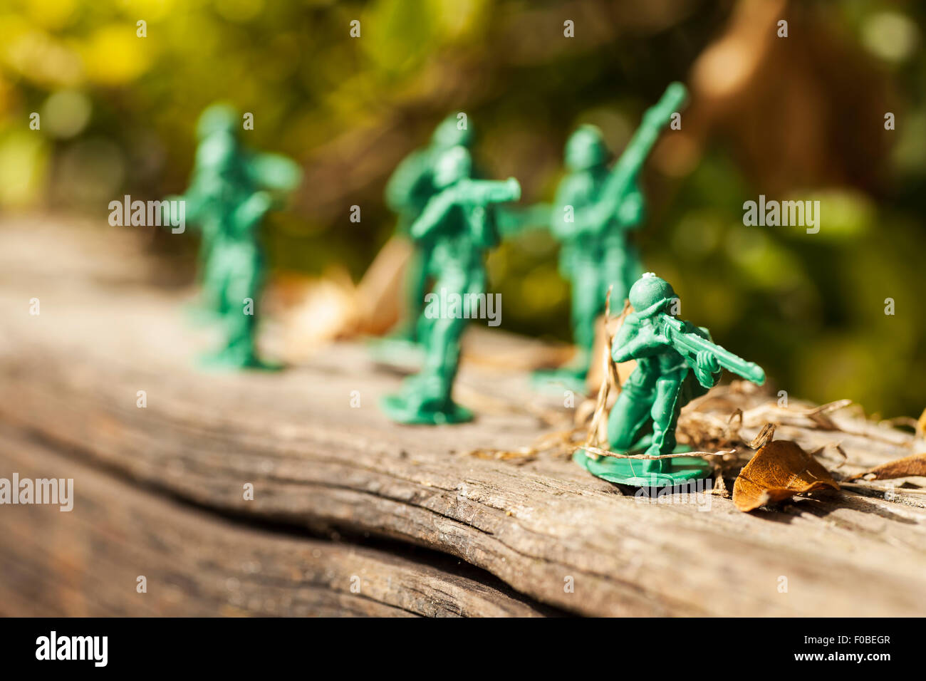 Green plastic toy soldiers/army men on a mission in the back garden ...