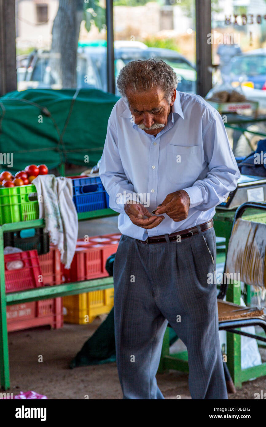 Old man market stall holder in the market in Paphos Old Town, Cyprus ...