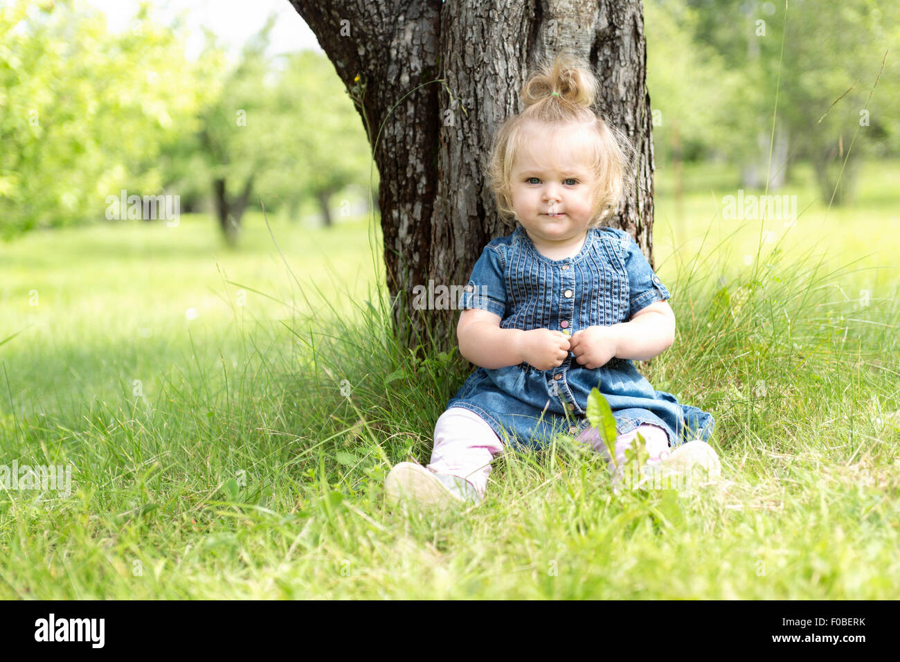 Adorable little girl in the forest meadow Stock Photo - Alamy