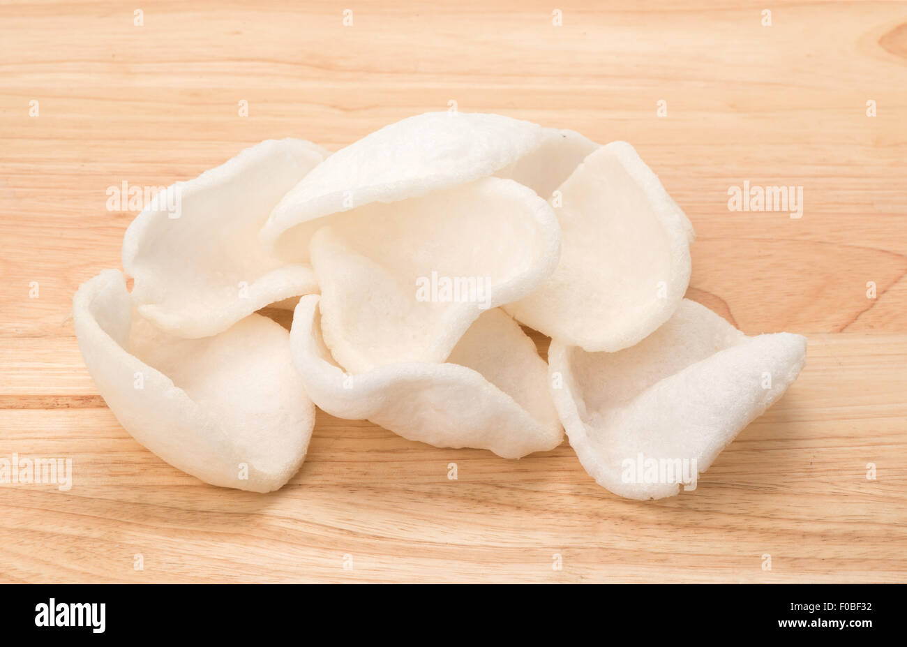Prawn crackers or shrimp chips on a wood background Stock Photo - Alamy