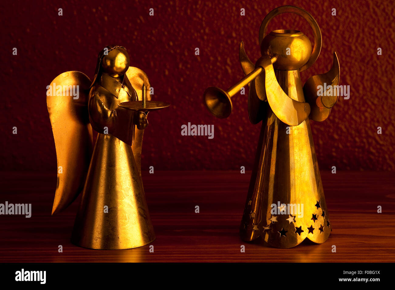 Bronze Metal angels playing music standing on desk candle holders Stock ...