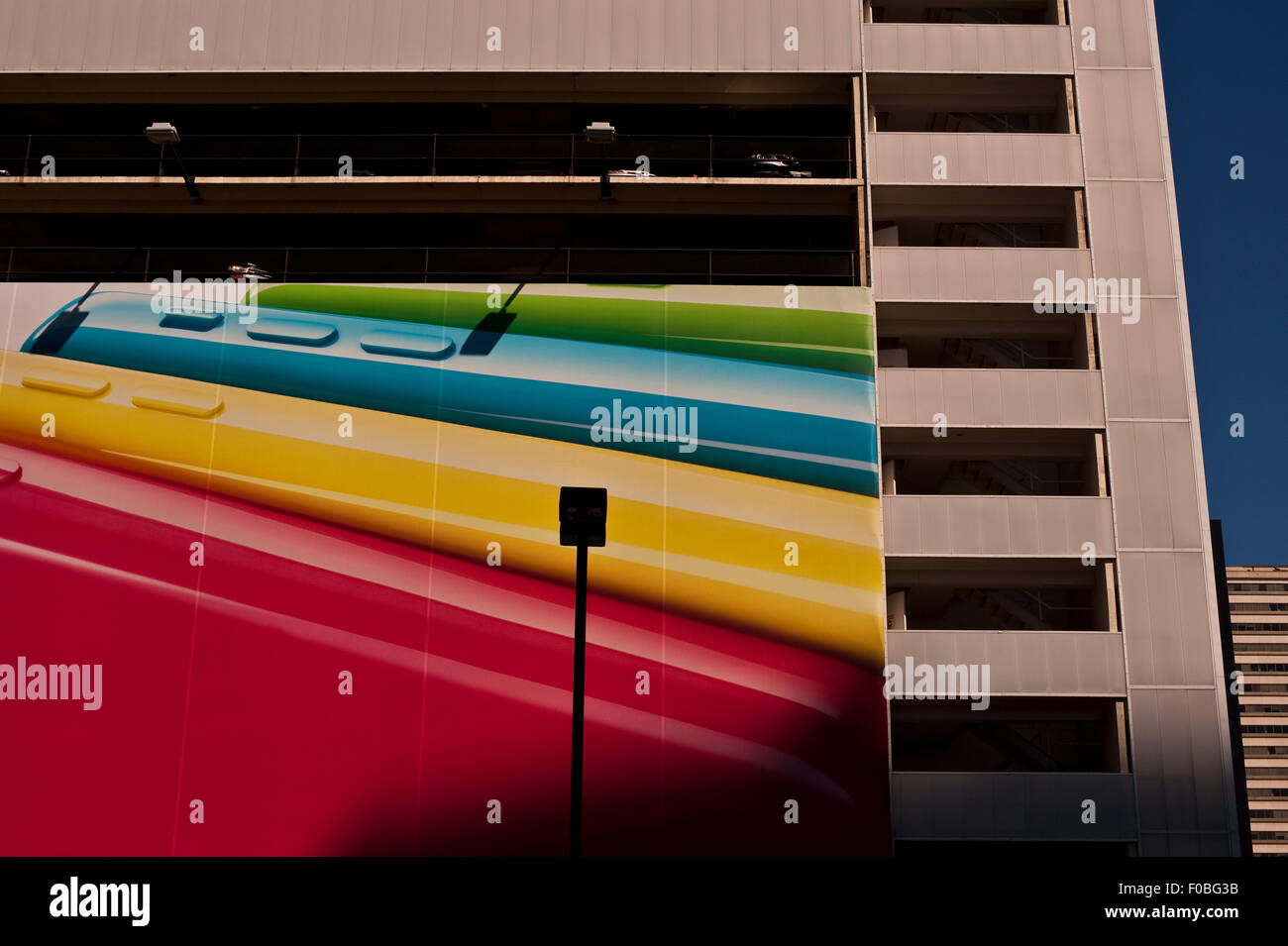 Side of parking garage building painted with a rainbow of colors ...