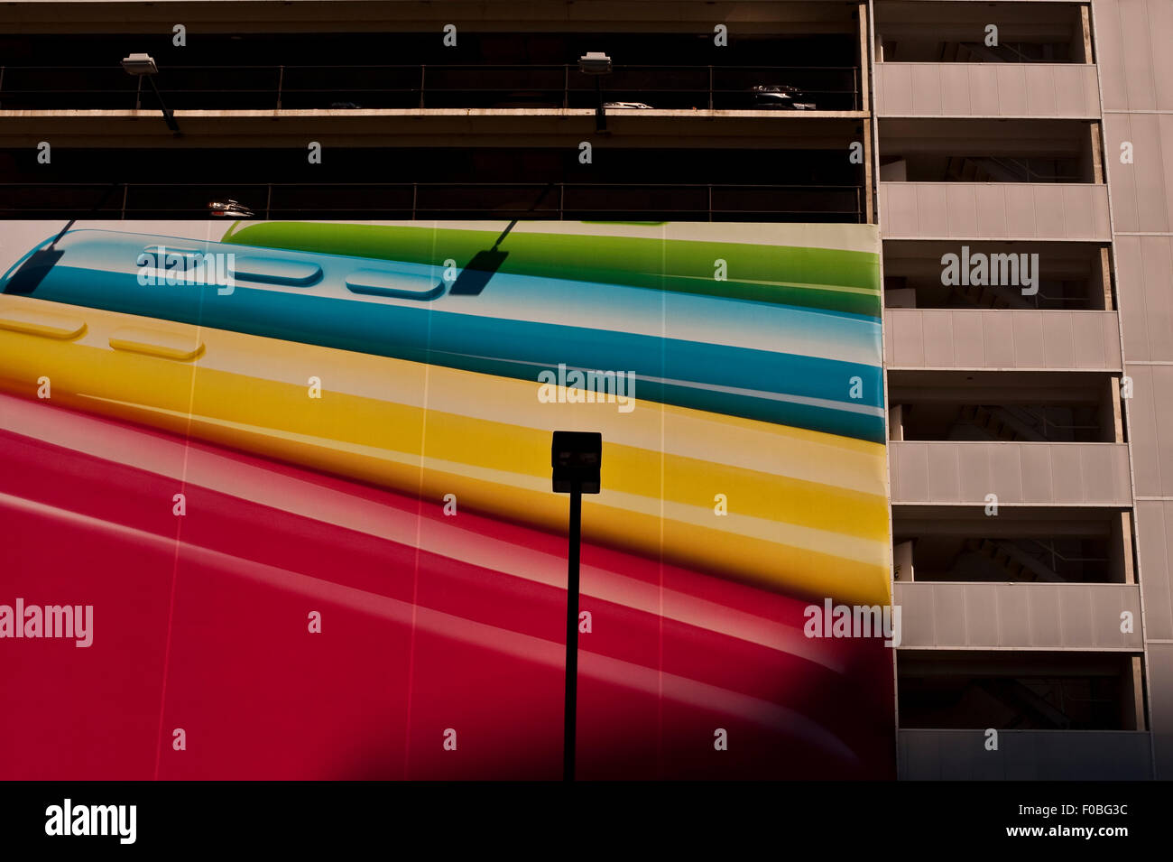 Side of parking garage building painted with a rainbow of colors ...