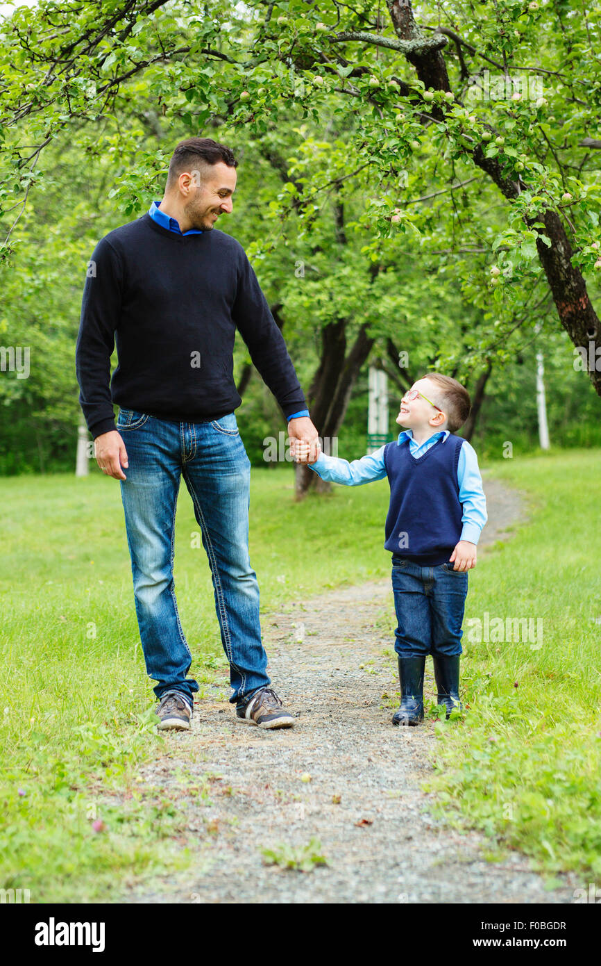 Father and son in forest on a meadow Stock Photo - Alamy