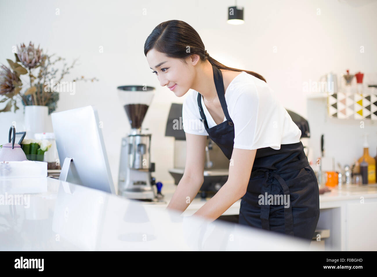Coffee shop owner using computer Stock Photo - Alamy