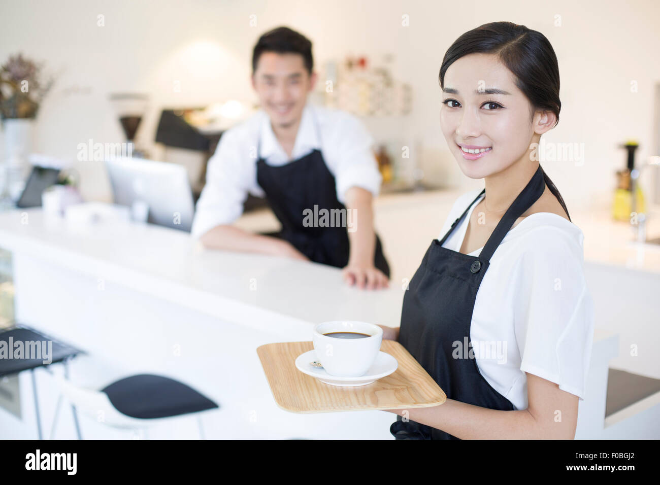 Portrait of coffee shop waitress Stock Photo - Alamy