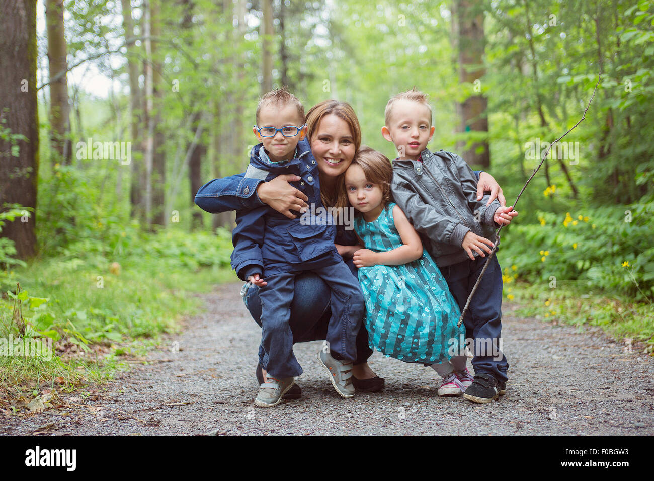 family in forest having fun together Stock Photo - Alamy
