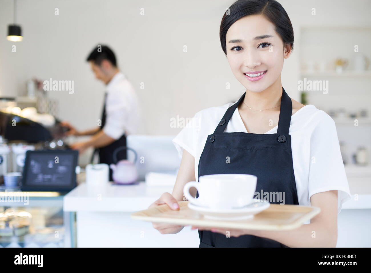 Portrait of coffee shop waitress Stock Photo - Alamy