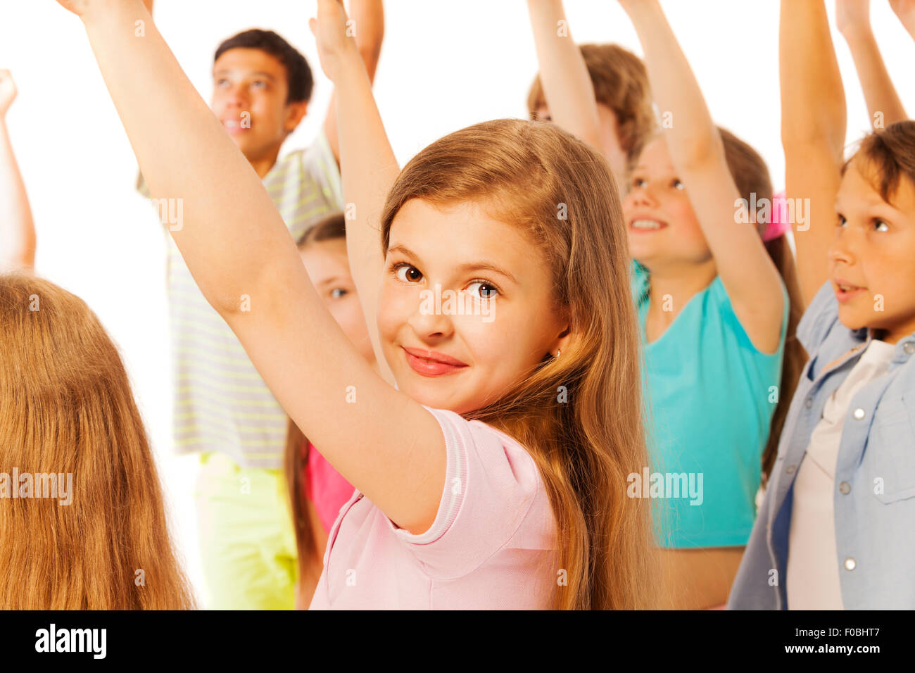 Girl in the crowd look back and smile Stock Photo - Alamy