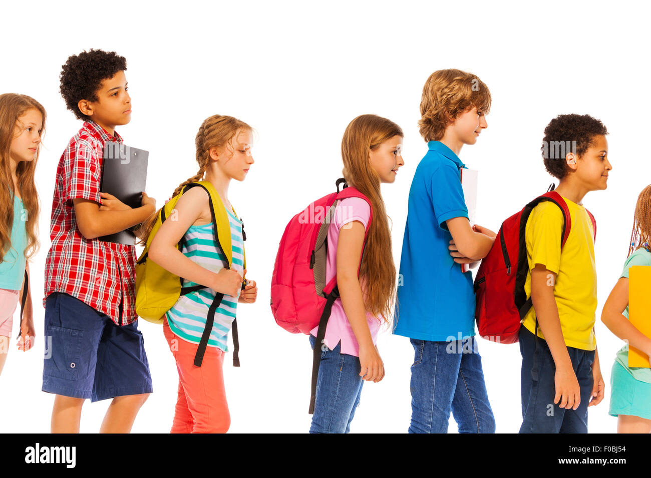School kids go in line with backpacks profile view Stock Photo - Alamy