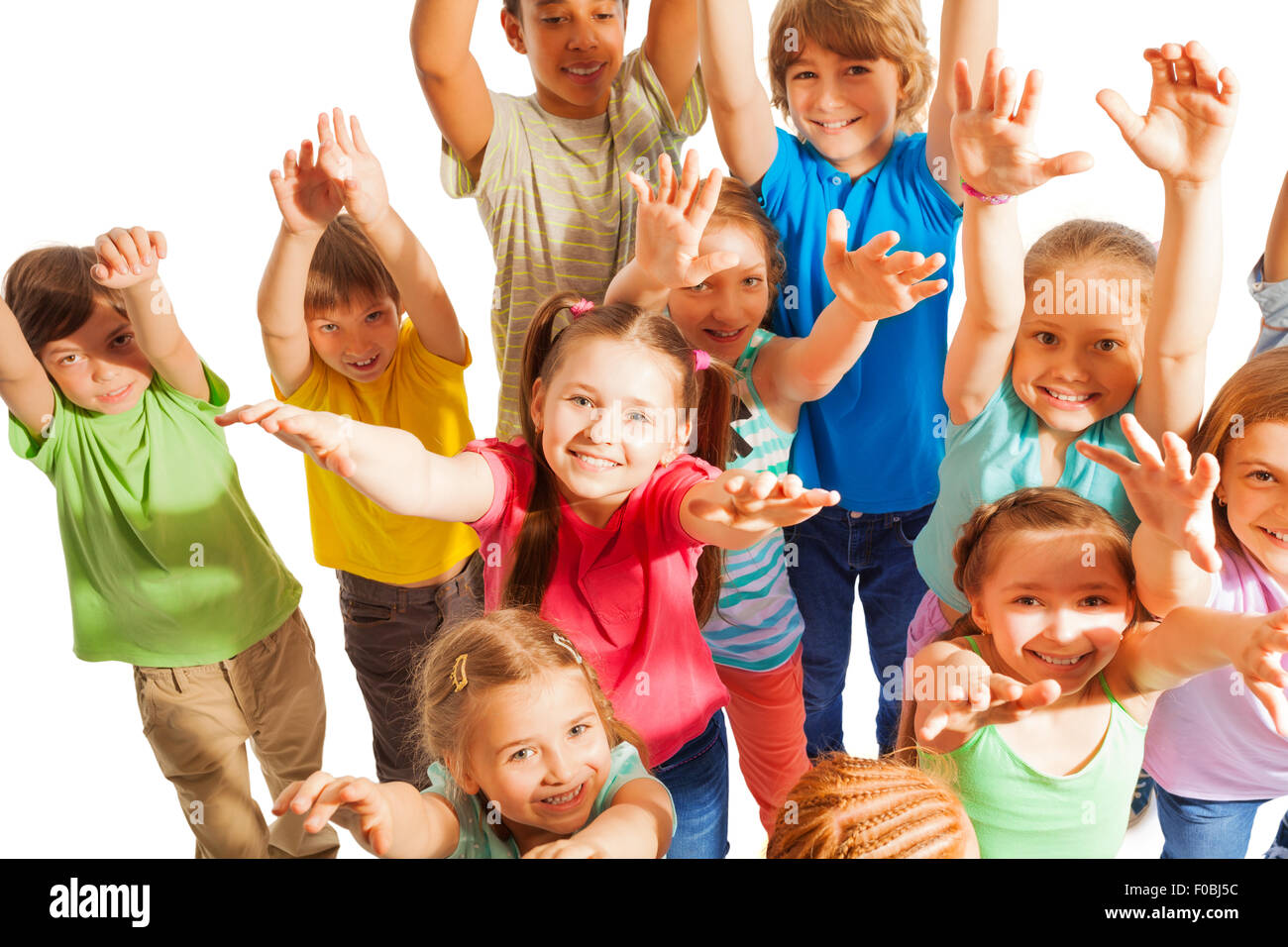 Crowd of kids rise hands up to camera Stock Photo - Alamy