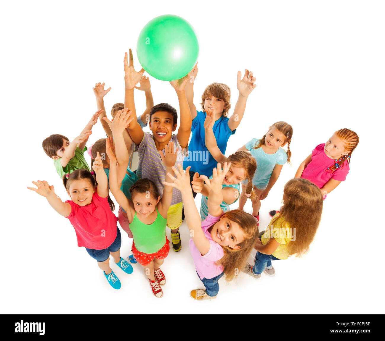 Group of kids catching green ball Stock Photo - Alamy