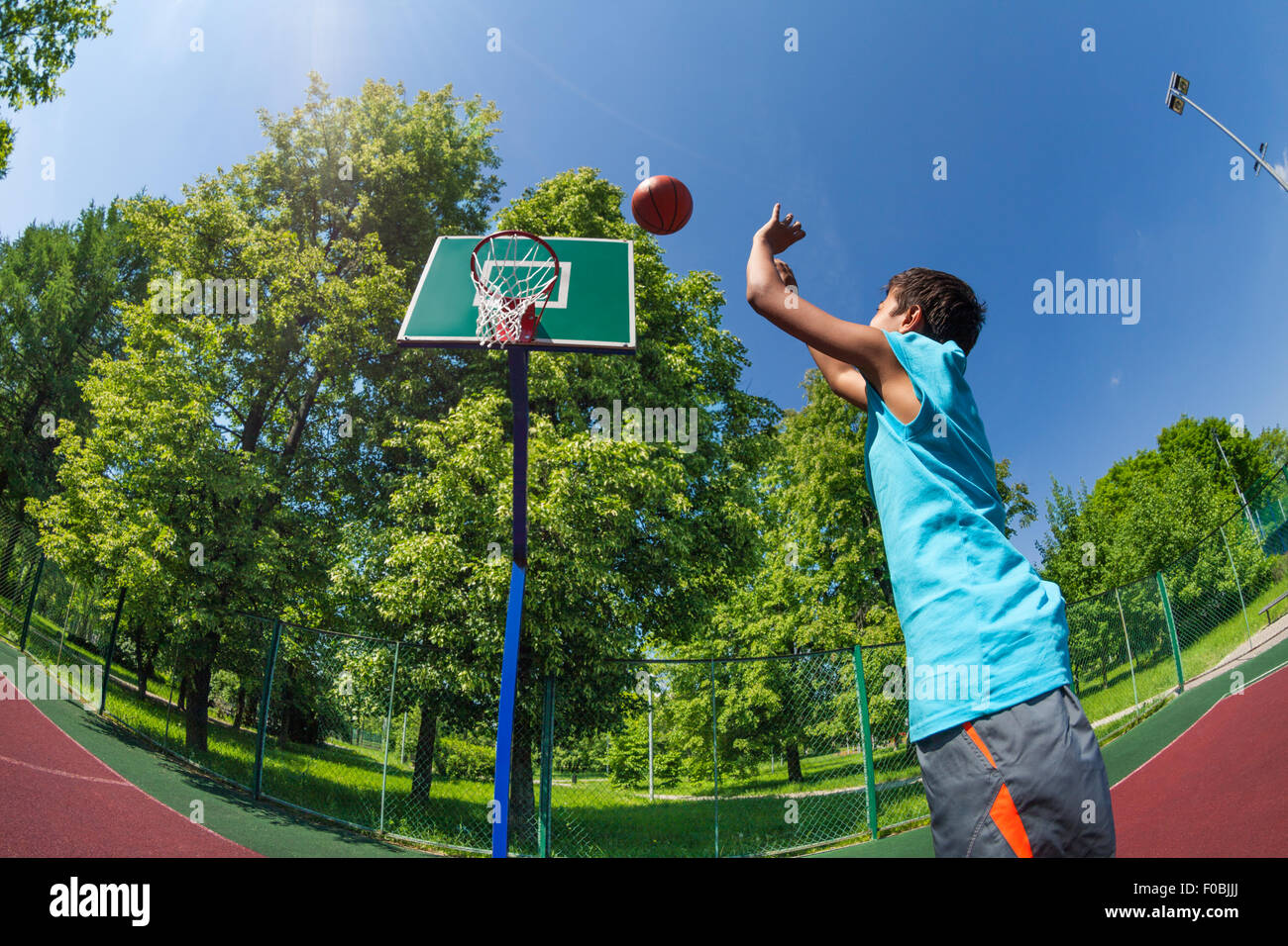 Arabian boy throws ball in basketball goal Stock Photo - Alamy
