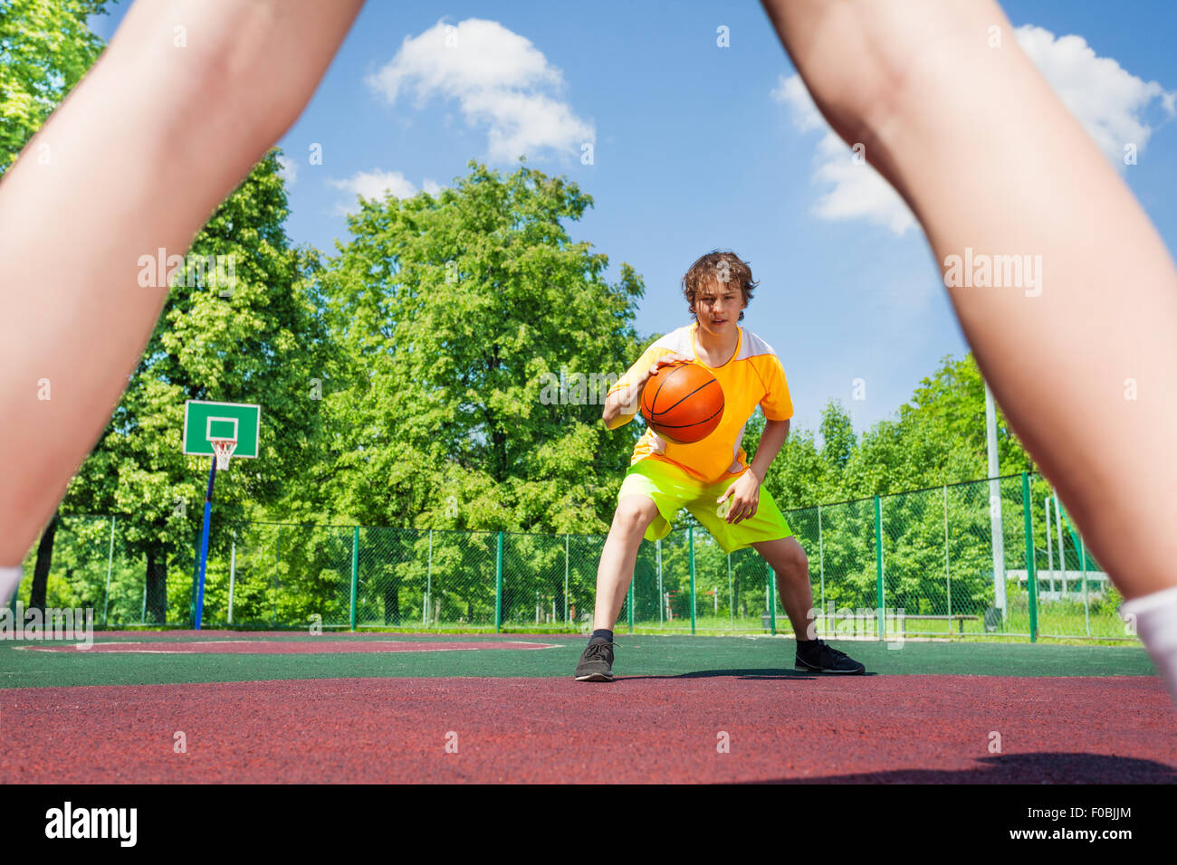 Boy with ball going to player at basketball Stock Photo - Alamy