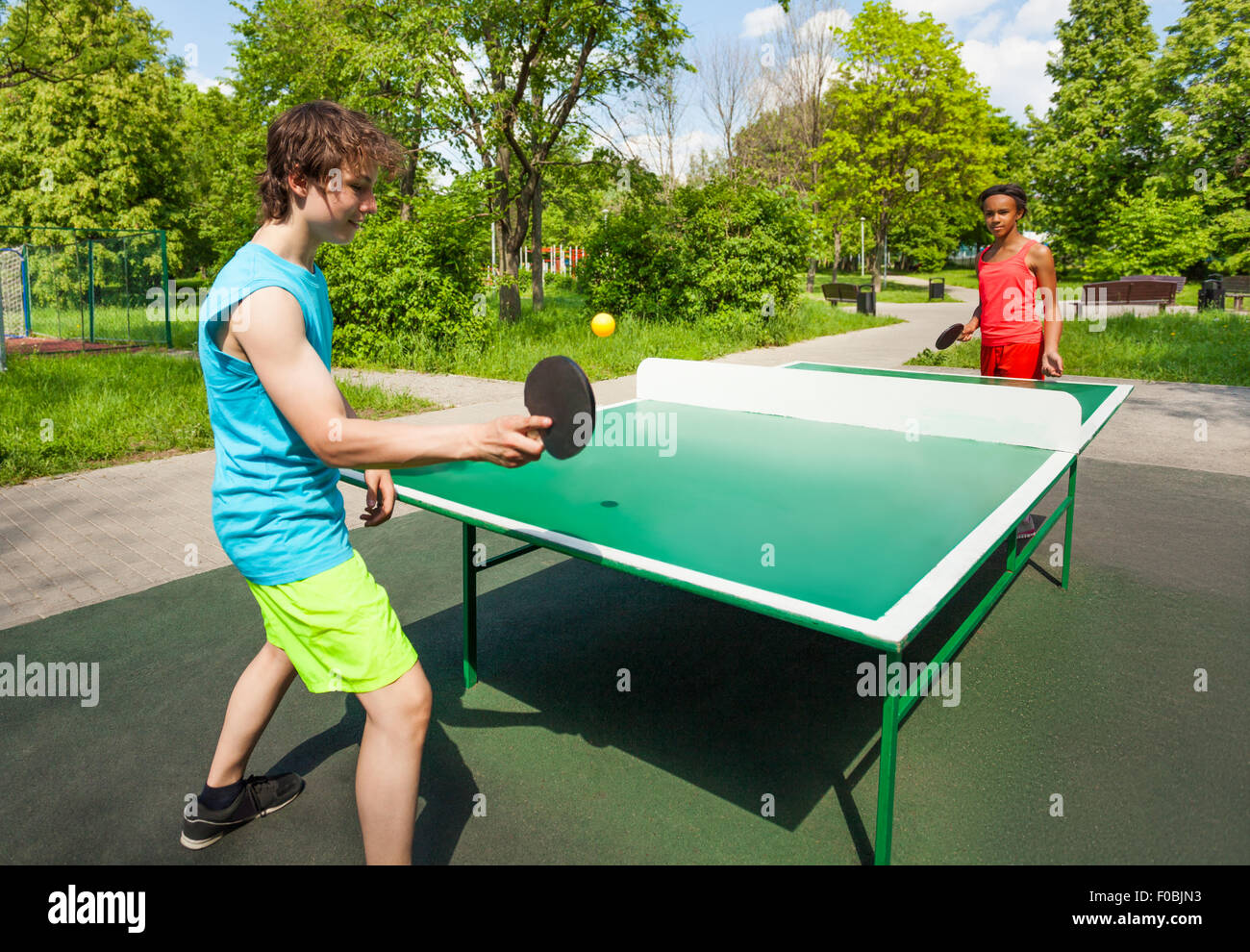 African girl and boy playing ping pong outside Stock Photo - Alamy