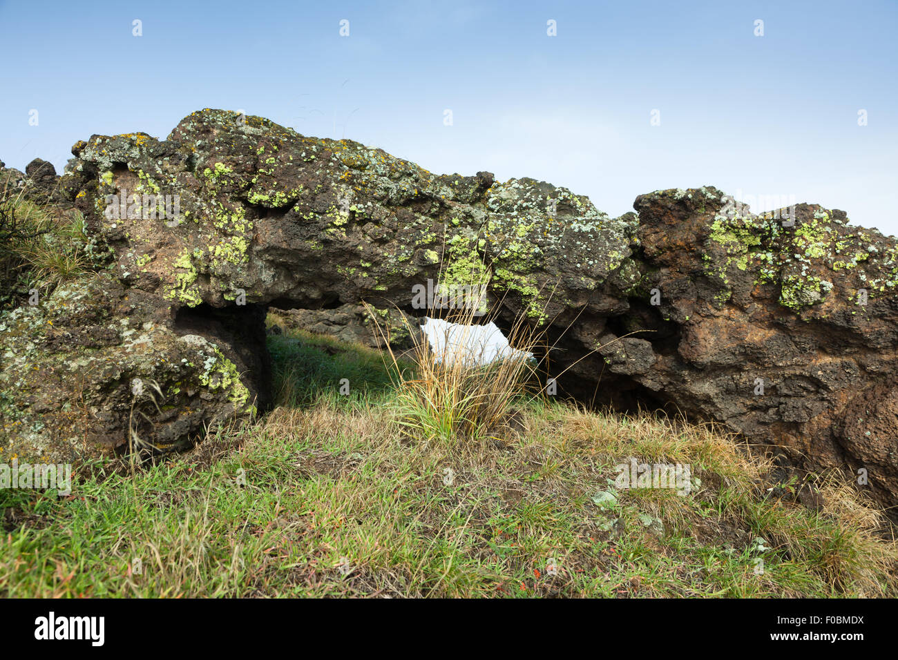 A small volcanic rock formation, with a face shape lower left, makes a ...