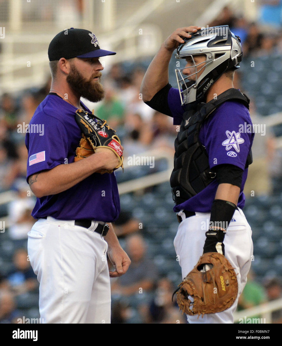 Usa. 11th Aug, 2015. SPORTS-- Isotopes catcher Dustin Garneau confers ...